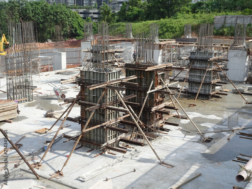Metal form work for concrete column installed by construction workers ...