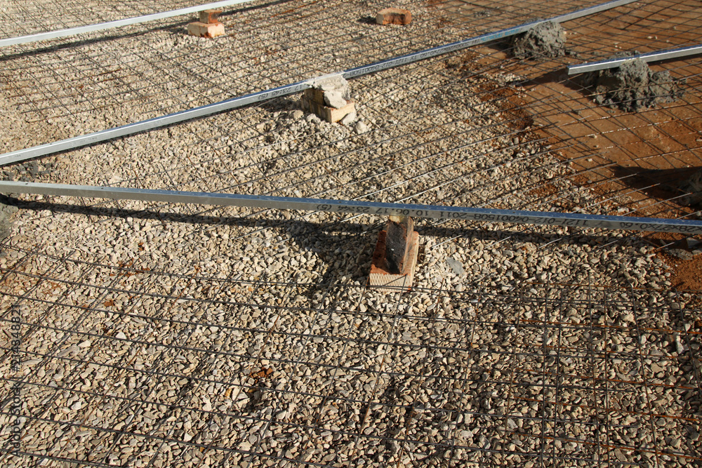 Screed rails and reinforcing meshes installed before concrete pouring ...
