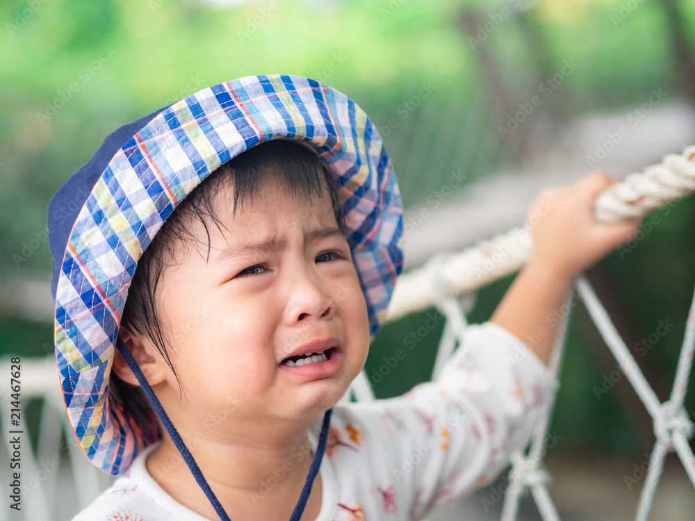 Sad little girl crying face on bokeh background with vintage filter ...