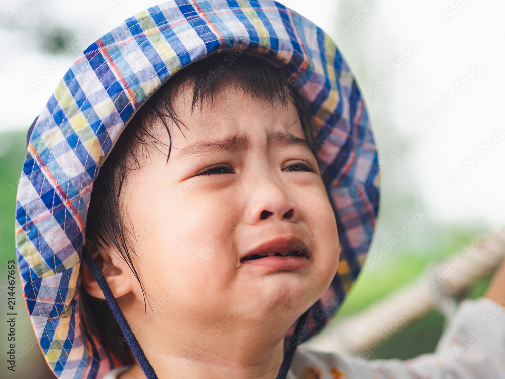 Sad little girl crying face on bokeh background with vintage filter ...
