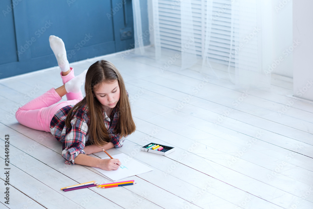 kid drawing hobby. childhood moments. little girl lying on the floor ...