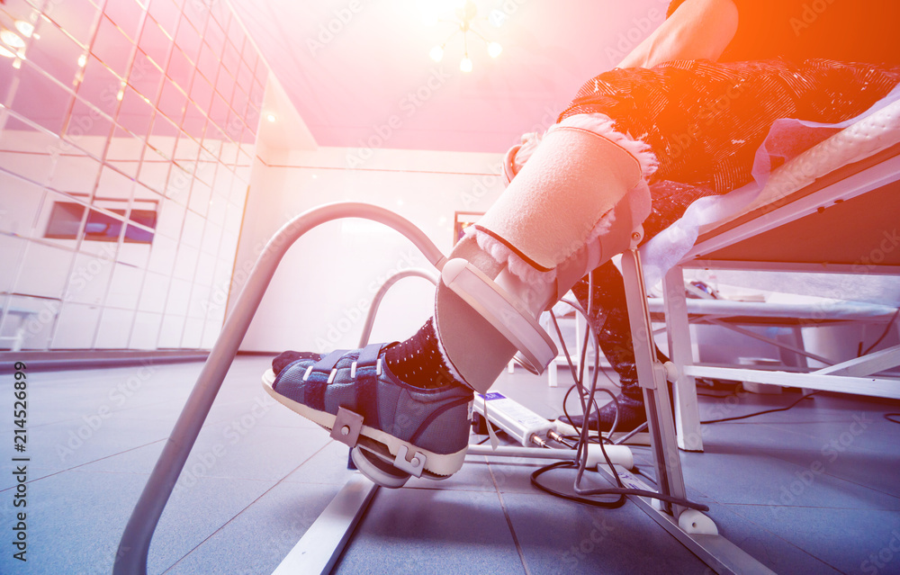 Patient on CPM (continuous passive range of motion) machines. Device to ...