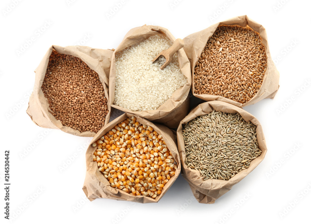 Paper bags with different types of grains and cereals on white ...