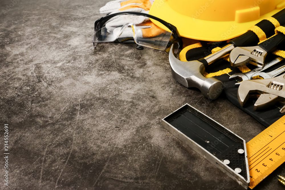 Construction safety equipment and tools on concrete texture background ...