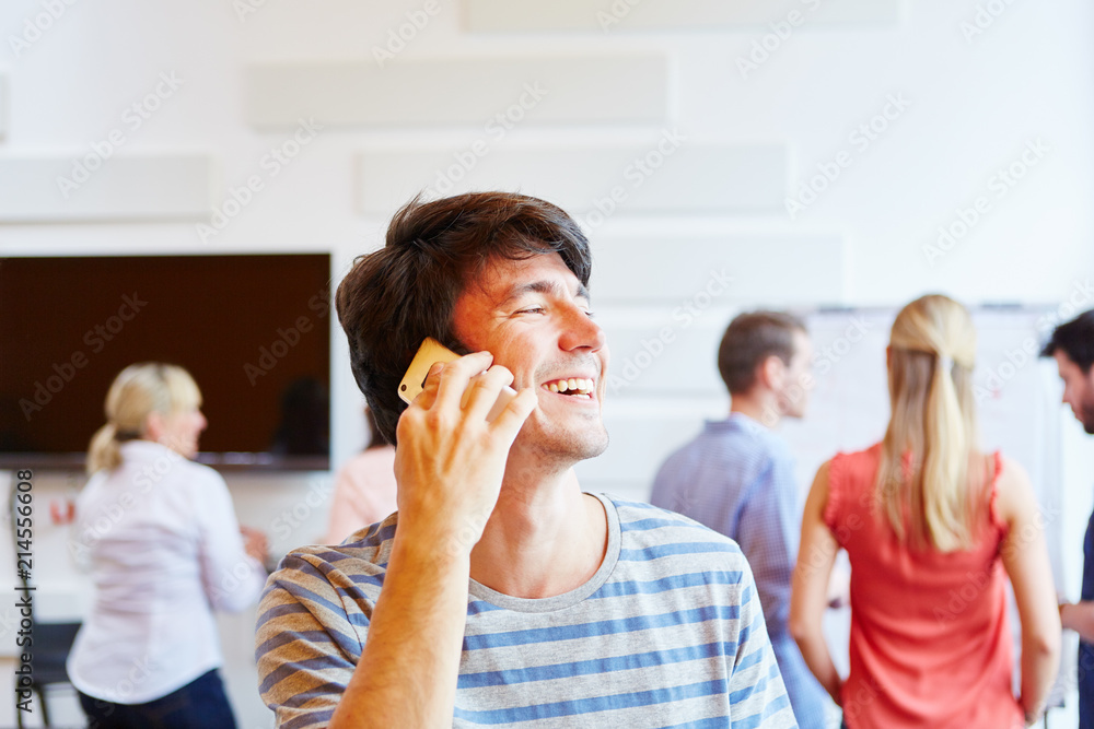 Man with smartphone happy about message Stock Photo | Adobe Stock