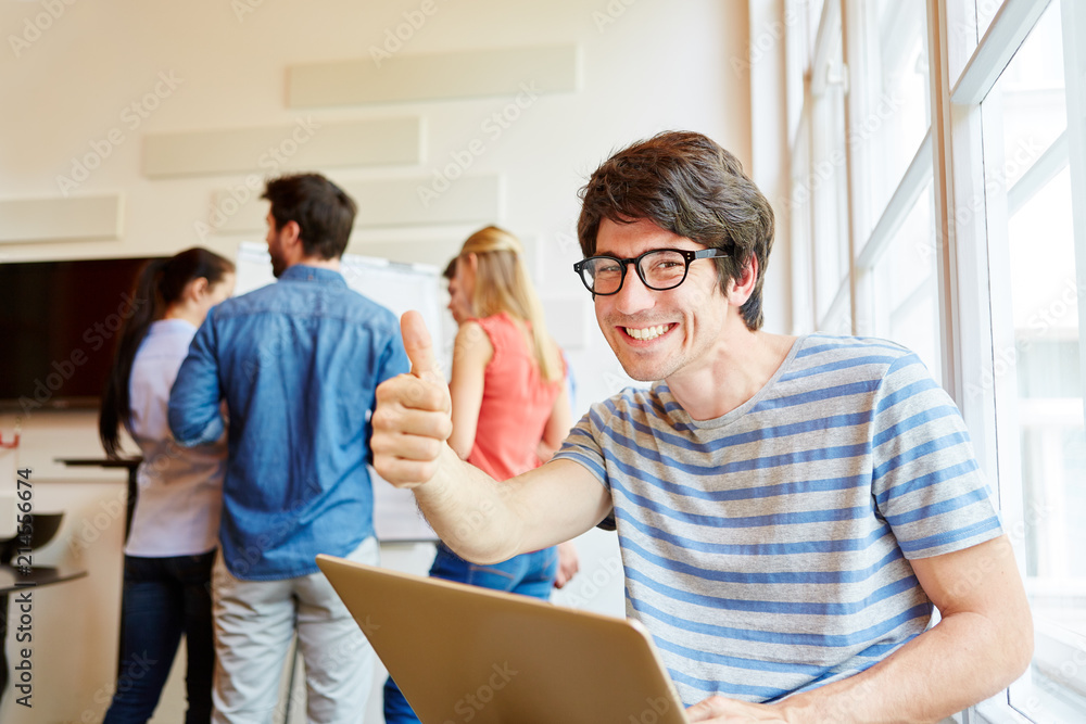 Nerd student holding thumbs up Stock Photo | Adobe Stock