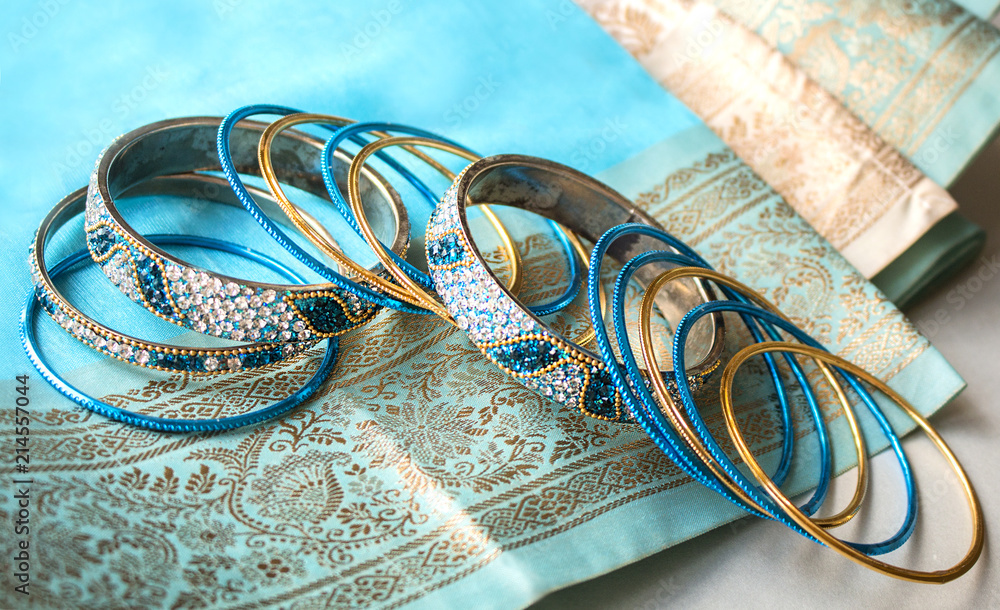Indian style bracelets (bangles) on the blue sari background. Blue and ...