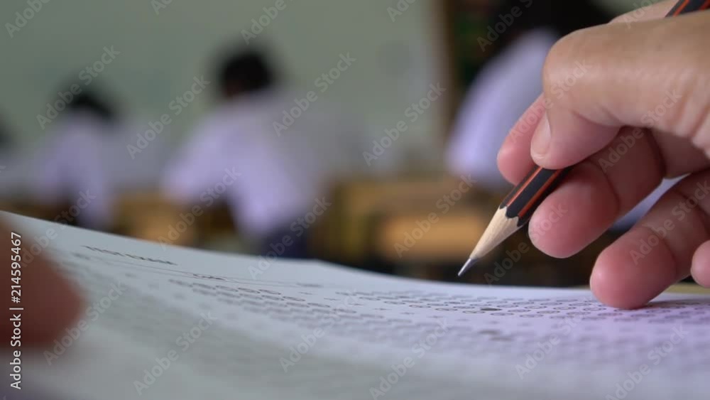 Hands with pencil over application form, Students taking exams, writing ...