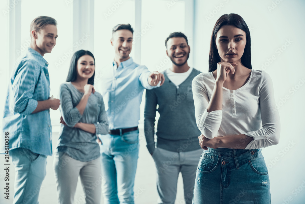 Group Of People Pointing And Laughing At Someone