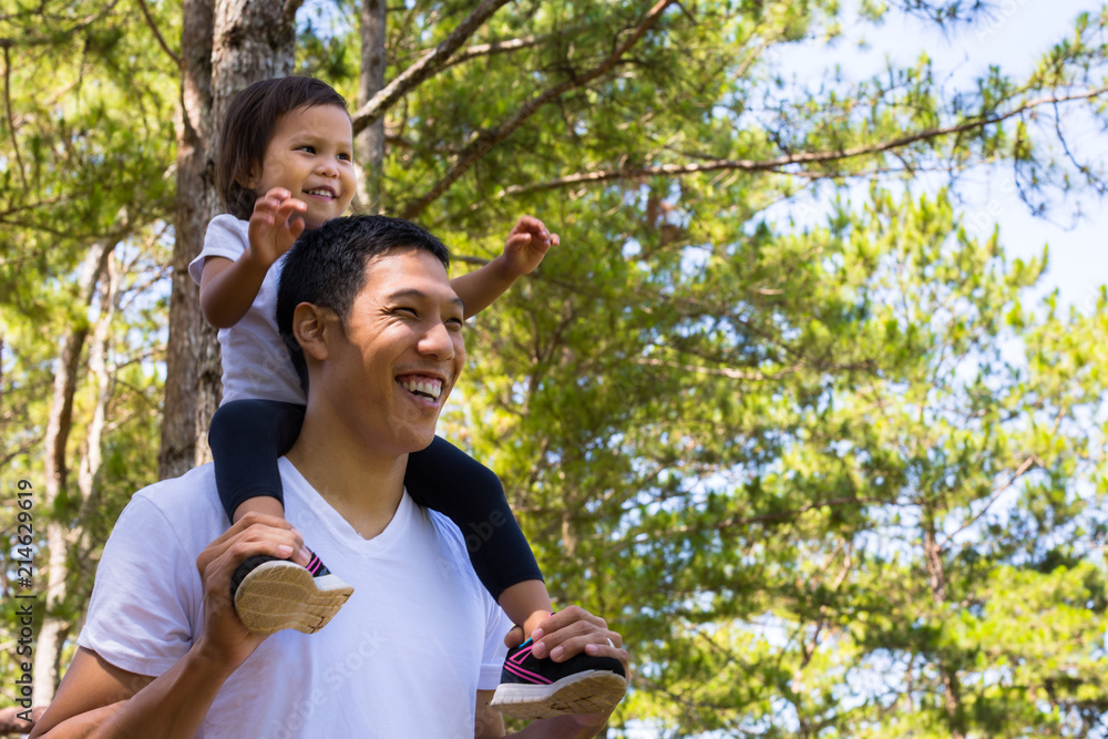 Father and child have a fun day outside, laughing and playing together ...