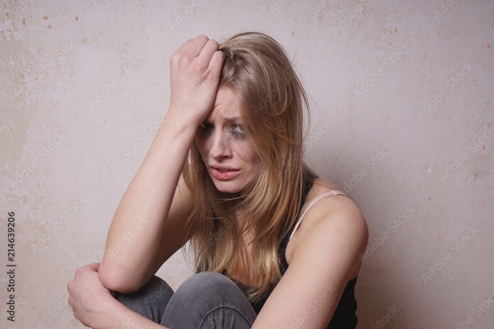 sad young woman with tear-stained face and smudgy makeup from crying ...