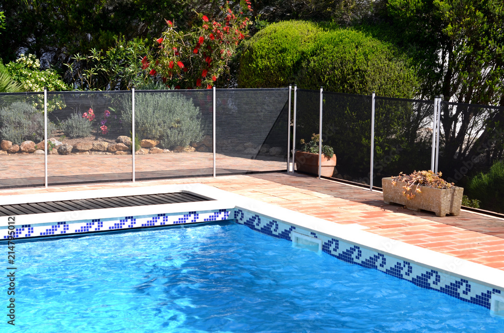 Swimming pool with safety fence Stock Photo | Adobe Stock