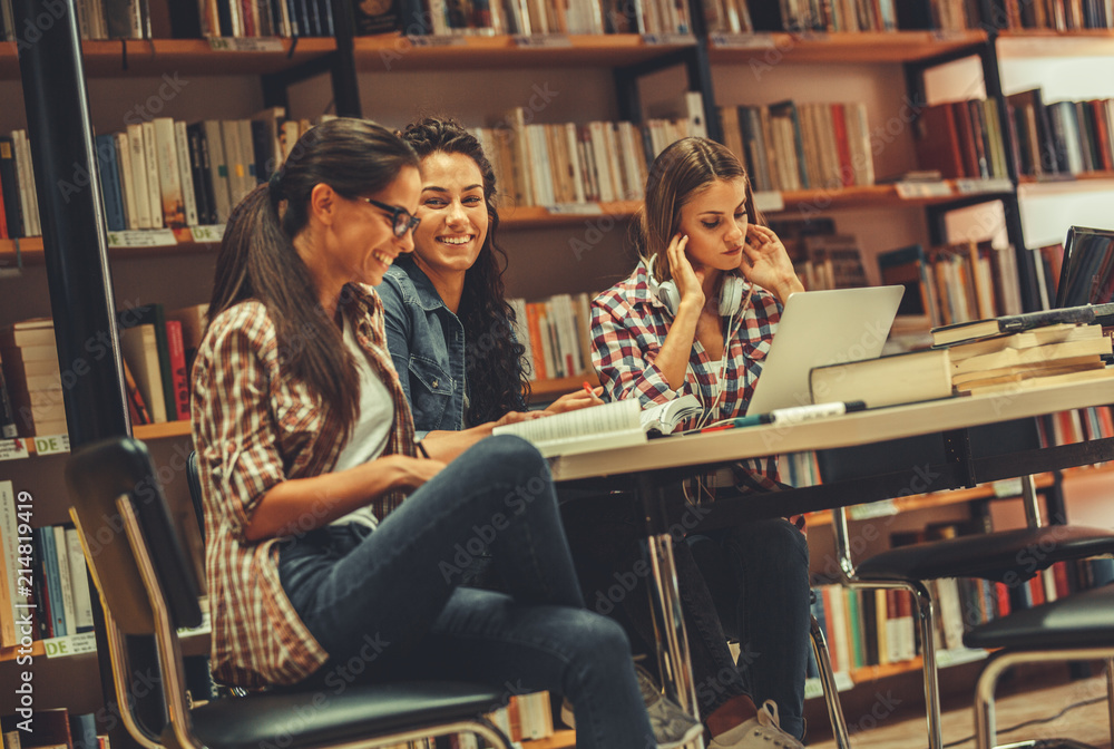 Cute female students study in the university campus library.Learning ...