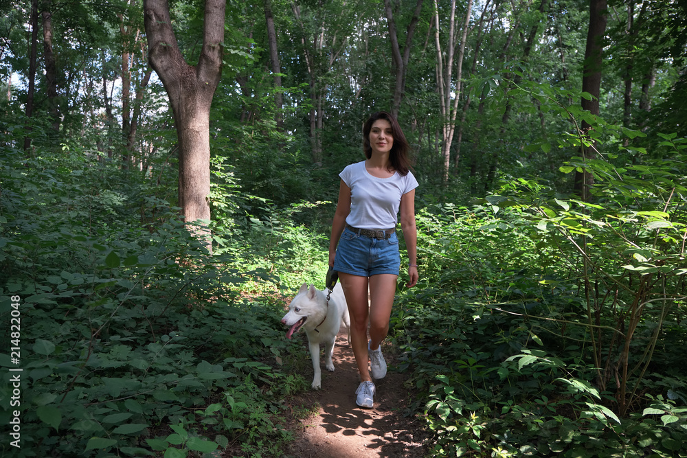 Beautiful woman walking her dog Stock Photo | Adobe Stock