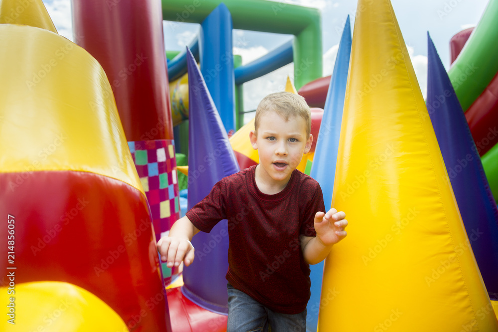 Child jumping on colorful playground trampoline. Kids jump in ...