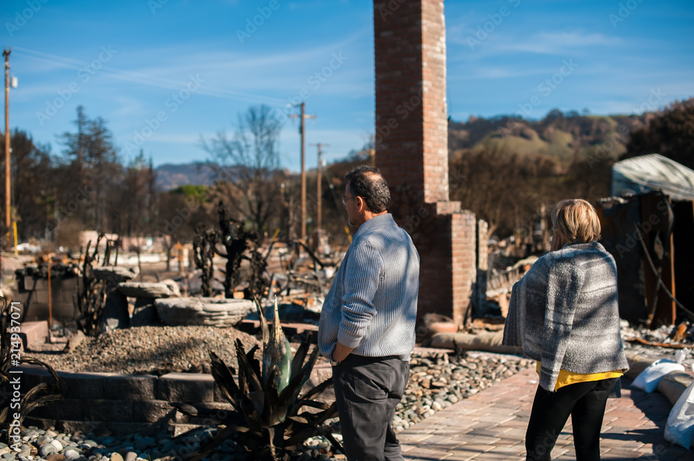 Man and his wife owners, checking burned and ruined of their house and ...