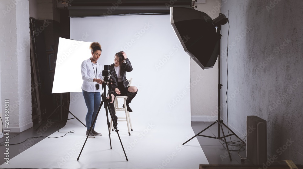 Female photographer and model interacting with each other Stock Photo ...