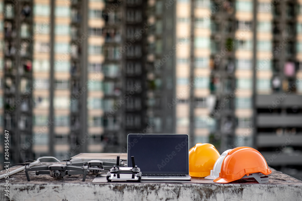 Drone, remote control, laptop computer and protective helmet at ...