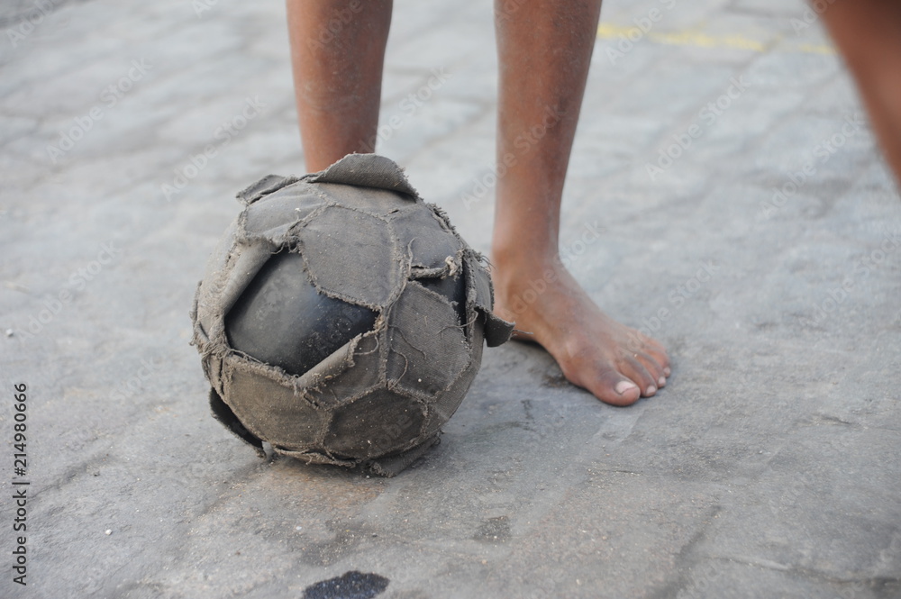 detail of feet and ball of a young poor football player Stock Photo ...