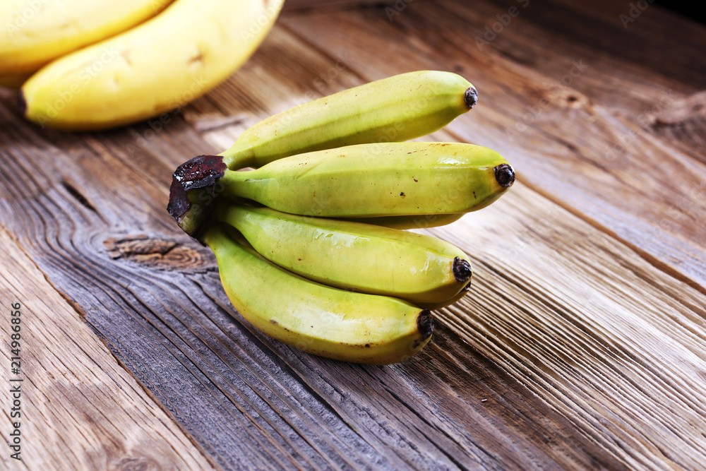 A banch of mini bananas and big banana over a table Stock Photo | Adobe ...