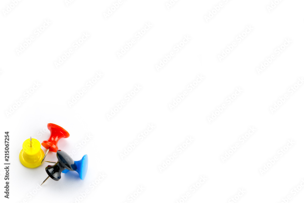 Pin photo illustration. Blue, black, red and yellow push pin set in ...