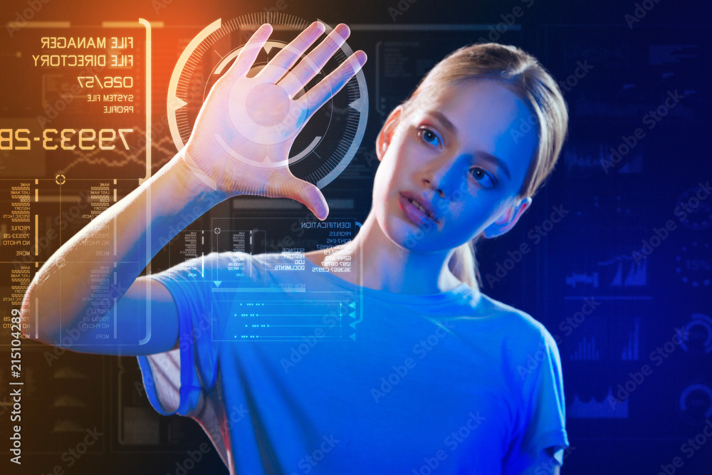 Hand scanning. Calm attentive progressive teenager scanning her hand ...