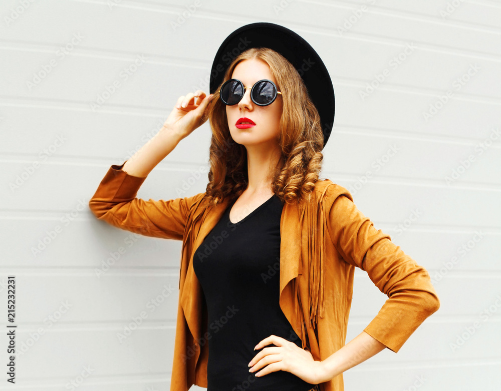 Beautiful woman model wearing a black hat, sunglasses and jacket ...