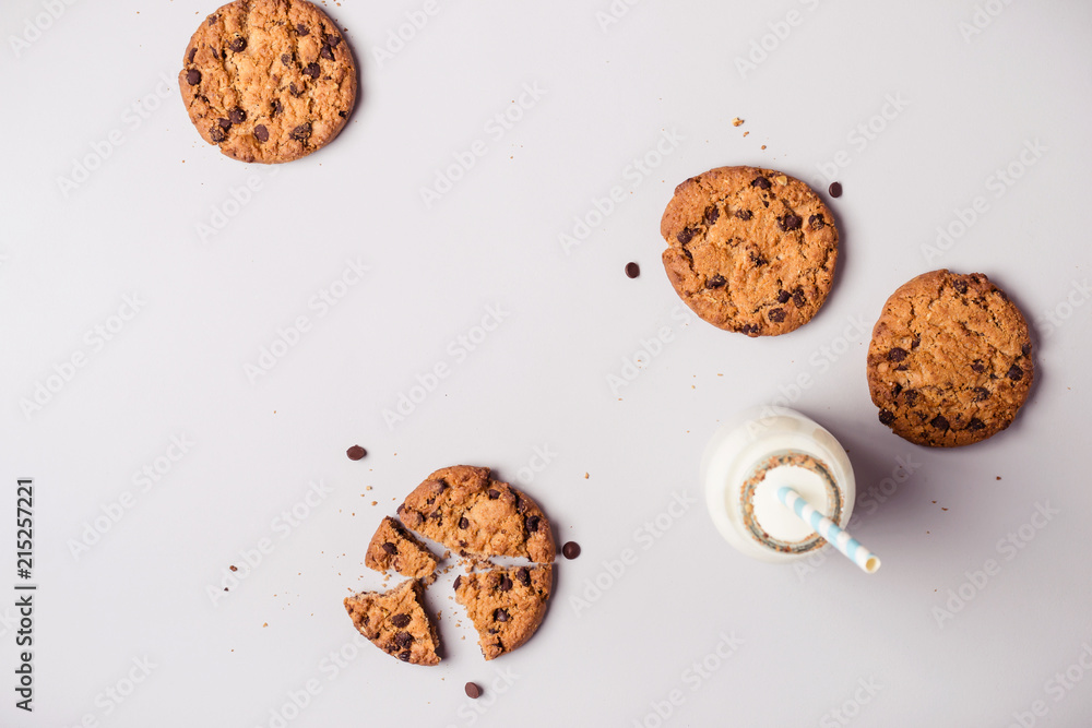 gray food Background with chocolate chip cookies and bottle of milk ...