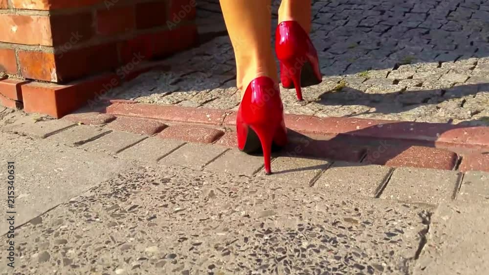 Sexy woman legs in red high heels shoes walking in the city urban ...