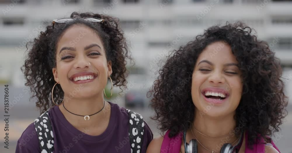 portrait beautiful young hispanic twin sisters laughing together lively ...