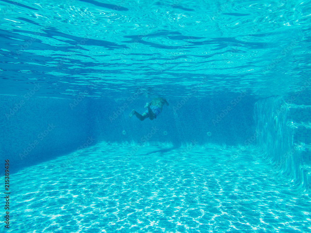 underwater image of an outside villa swimming pool with some steps at ...