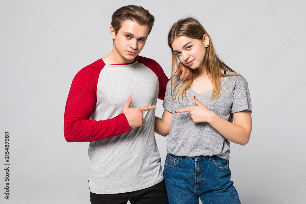 Blaming each other. Beautiful young couple pointing each other while ...