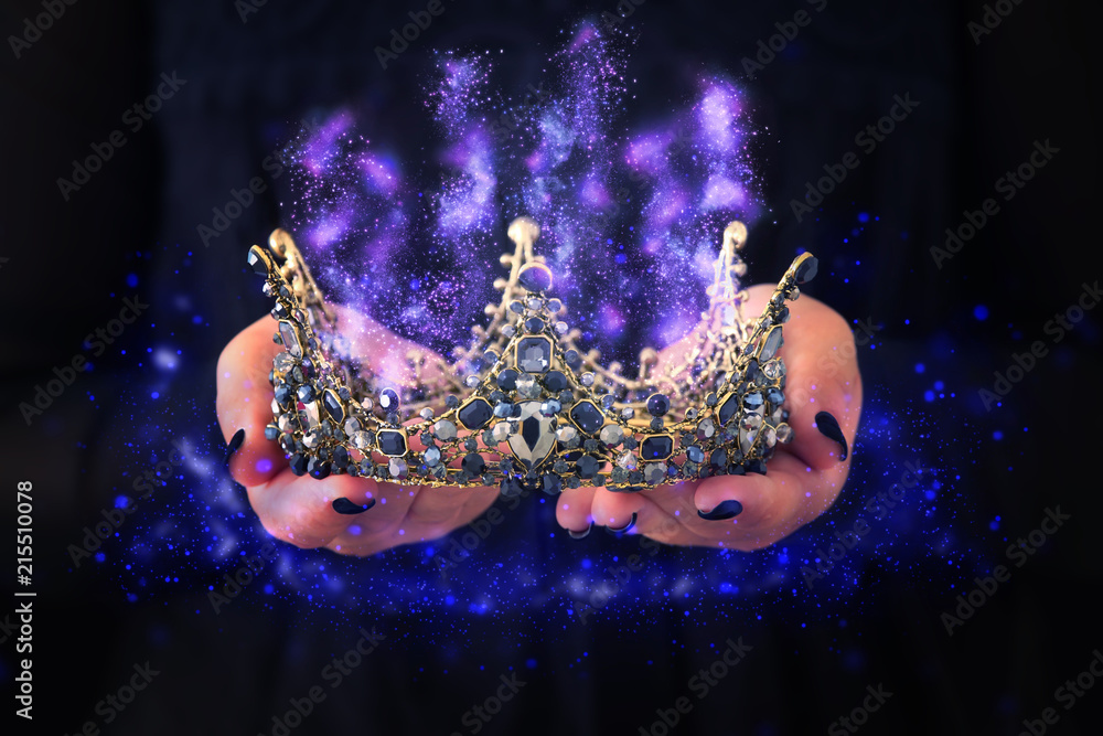 image of lady in black holding queen crown decorated with precious ...