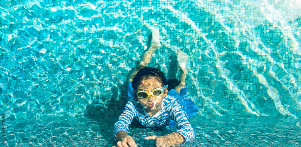 Happy little girl dive underwater in swimming pool.Happy child playing ...