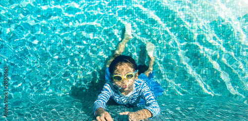 Happy little girl dive underwater in swimming pool.Happy child playing ...