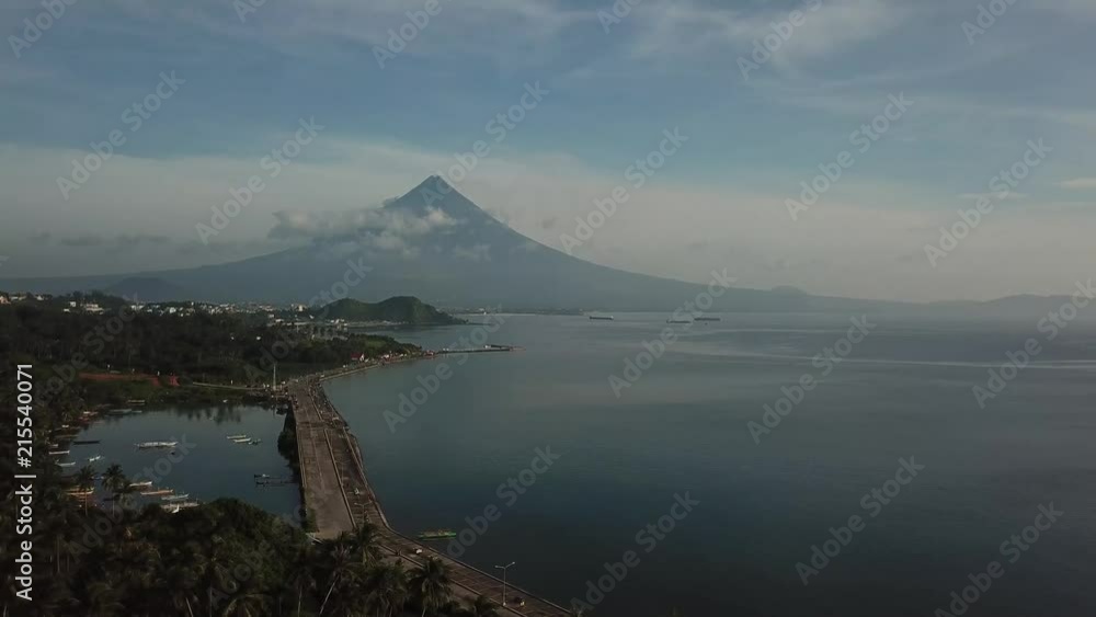 AERIAL SHOT: Pull away shot of Mayon Volcano with the Boulevard below ...