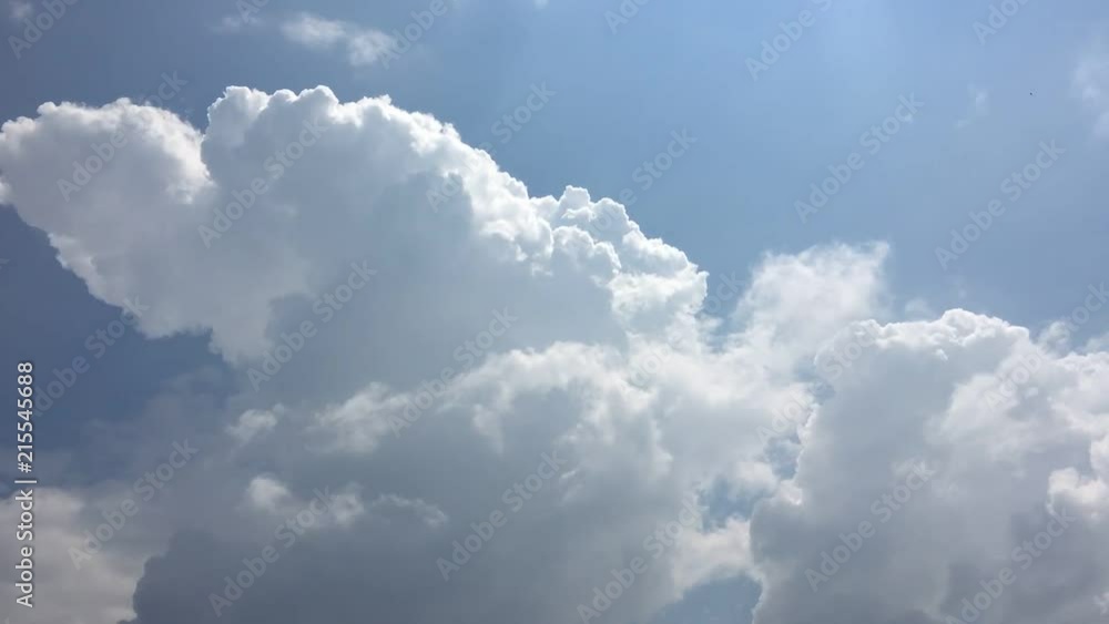 White clouds disappear in the hot sun on blue sky. Time-lapse motion ...