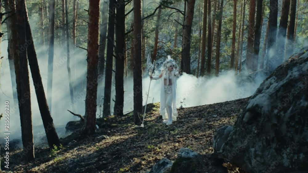 Satyr in white robe with ax axe and horns on the head appeared in the ...