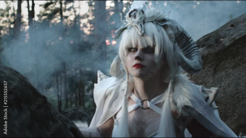 Girl dressed in costume of terrifying satyr character is creeping in ...