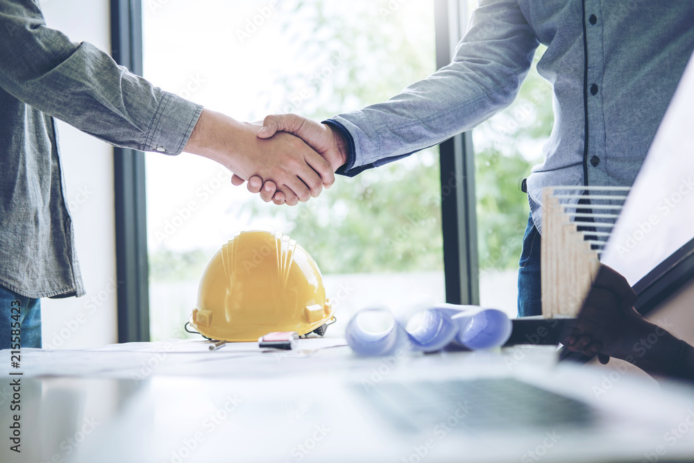 Engineer Handshake meeting for architectural project and working with ...