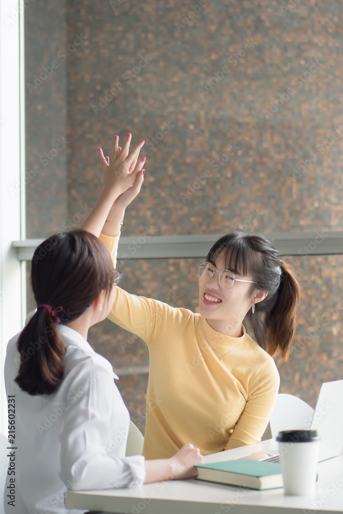 woman college students giving high five or hi 5 pose; portrait of ...