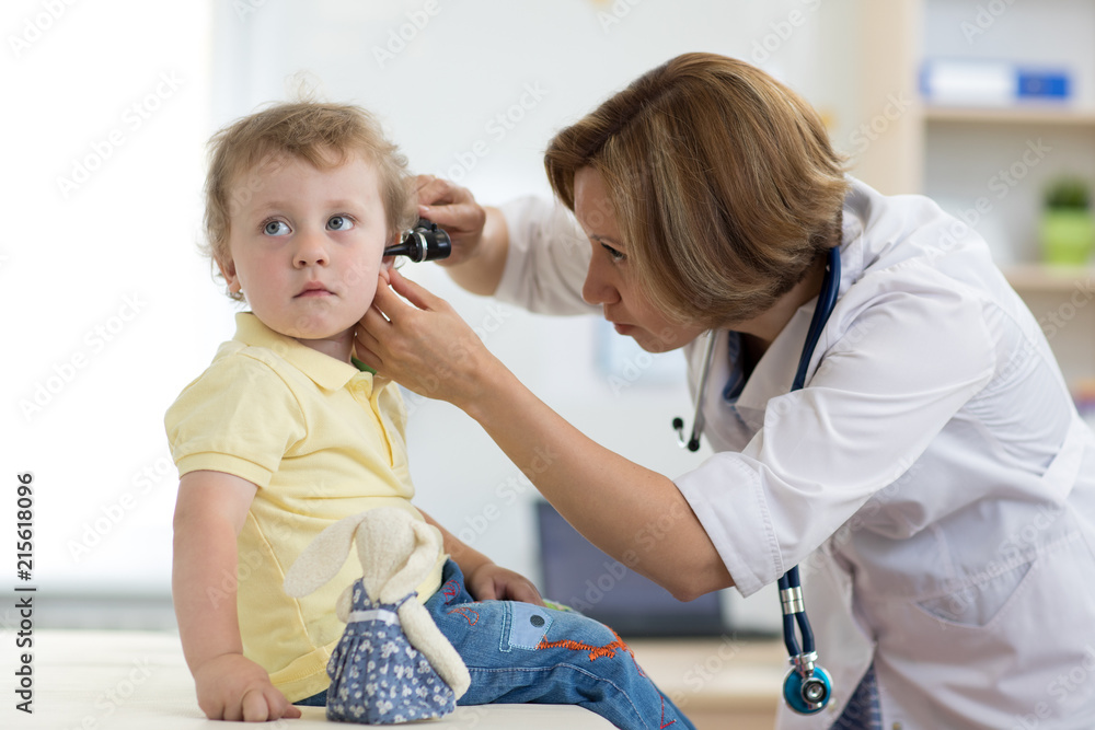 Pediatrician examining child's ears in doctor's office Stock Photo ...