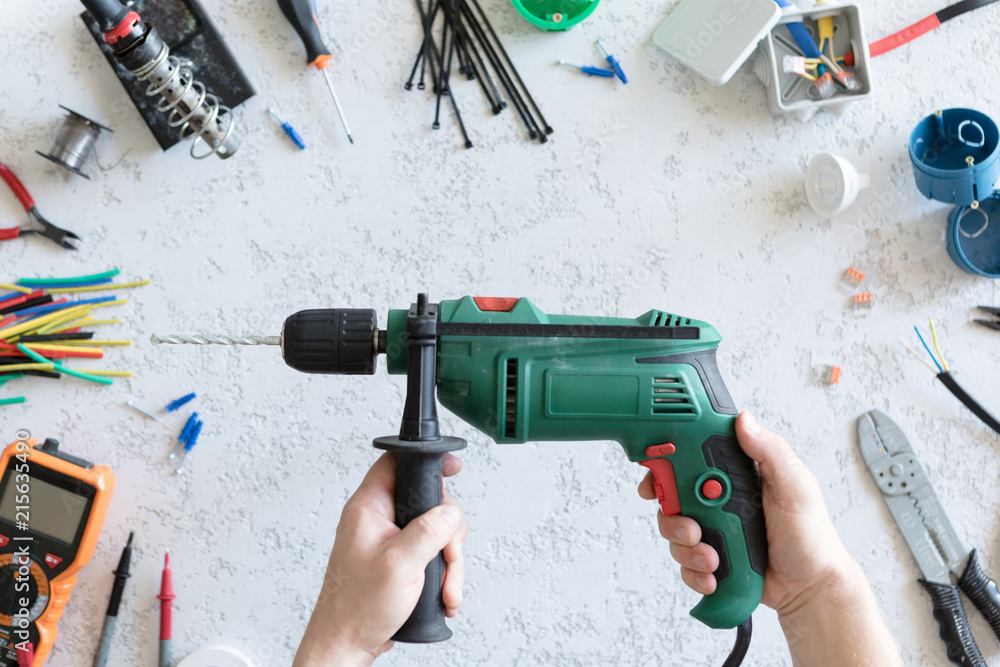 Top view of different electrical tools on white concrete background ...