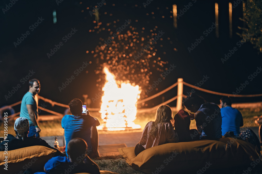 Group of people near camp fire with campfire song and campfire meals ...