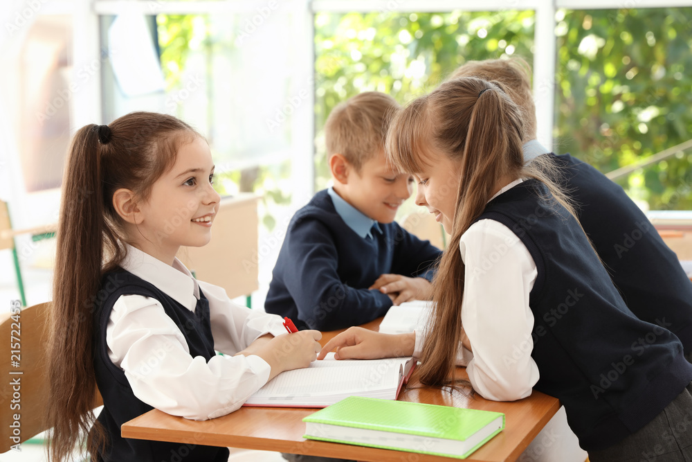 Little children in classroom. Stylish school uniform Stock Photo ...