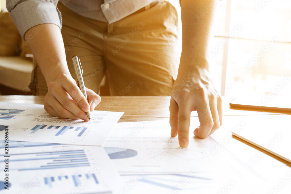 business people analyzing graph and chart document Stock Photo | Adobe Stock