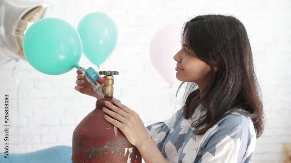 Girl blowing a balloon. Stock Video | Adobe Stock