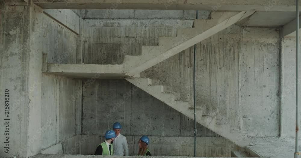 Team of engineers and architects lift up the stairs of construction ...