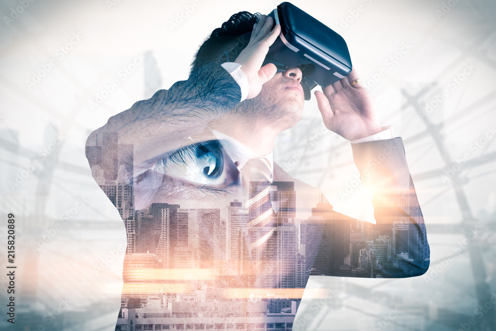 The double exposure image of the businessman wear a VR glasses during ...