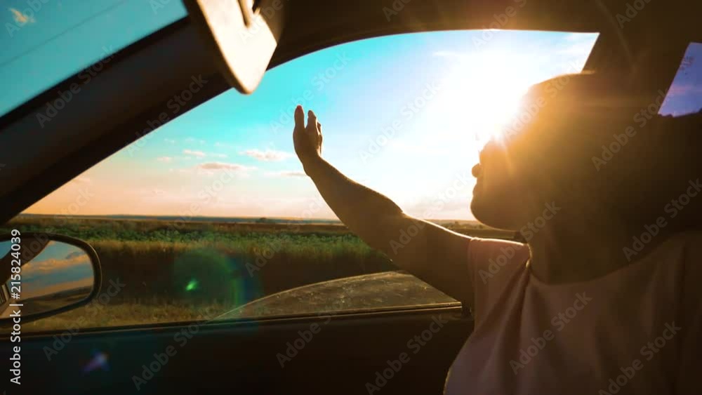 Video Stock girl waving her hand in the window sunlight the wind In car ...